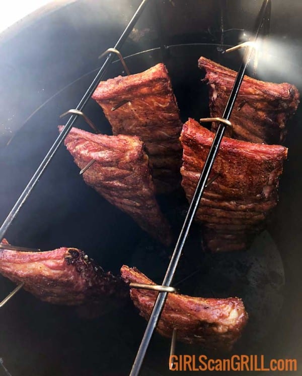 Hanging ribs on a drum smoker for competition BBQ - Girls Can Grill