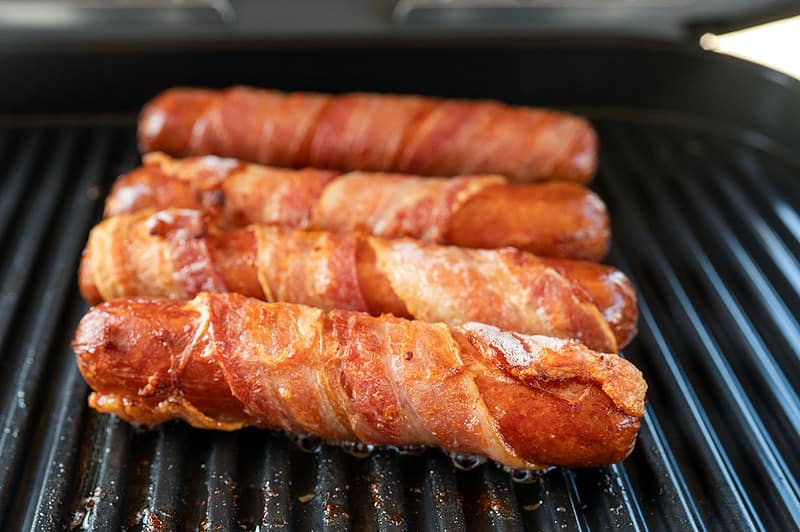 Bacon-wrapped hot dogs on the Ninja Grill - Girls Can Grill