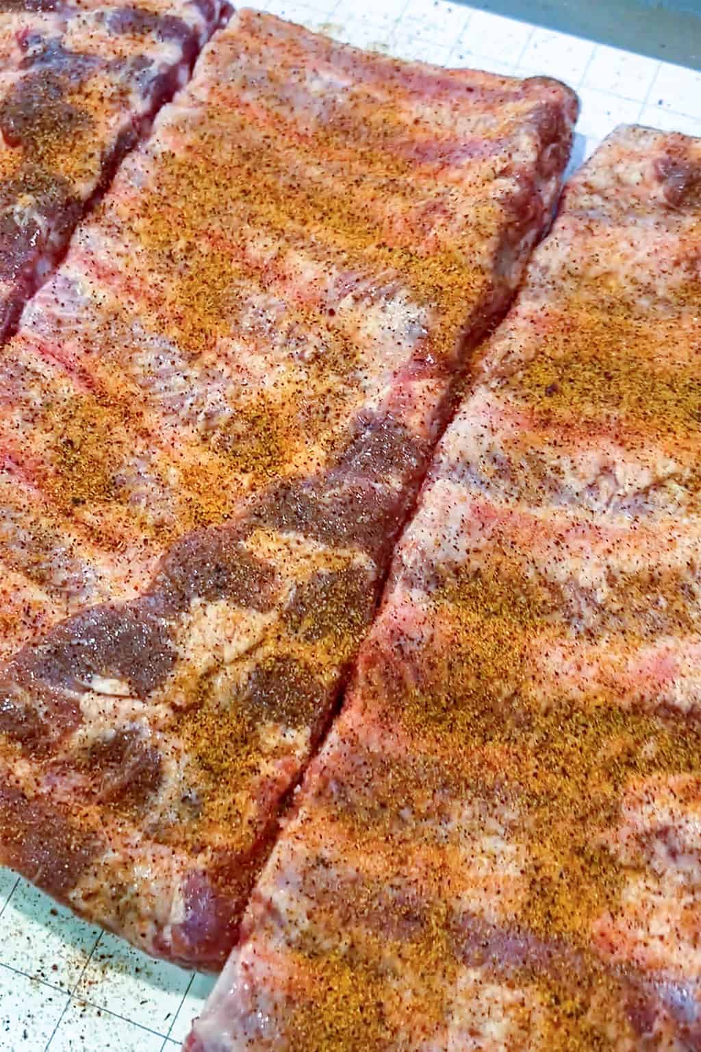 Hanging ribs on a drum smoker for competition BBQ - Girls Can Grill